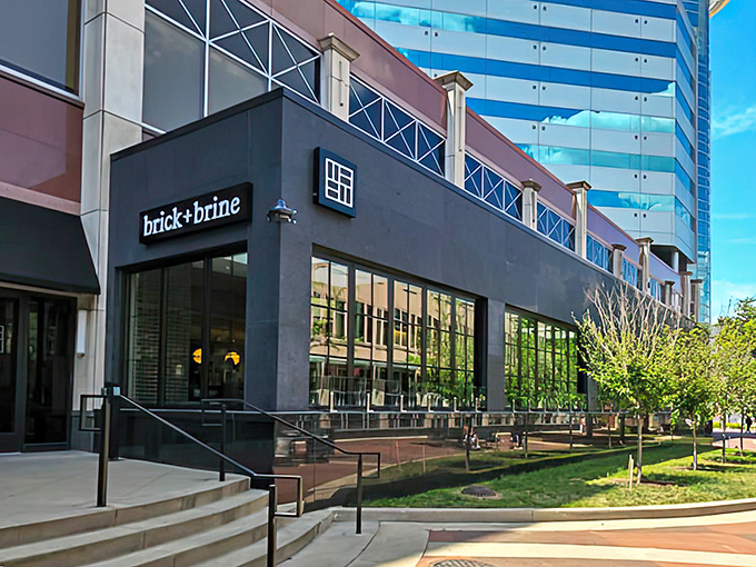 Sleek modern architecture meets Midwest charm at Brick + Brine's entrance, where culinary adventures begin behind those unassuming glass doors.