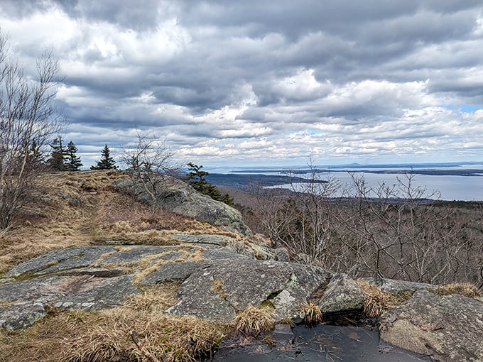 A peaceful overlook at Camden Hills State Park offers stunning ocean views, rocky terrain, and breezy skies perfect for a refreshing Maine adventure.