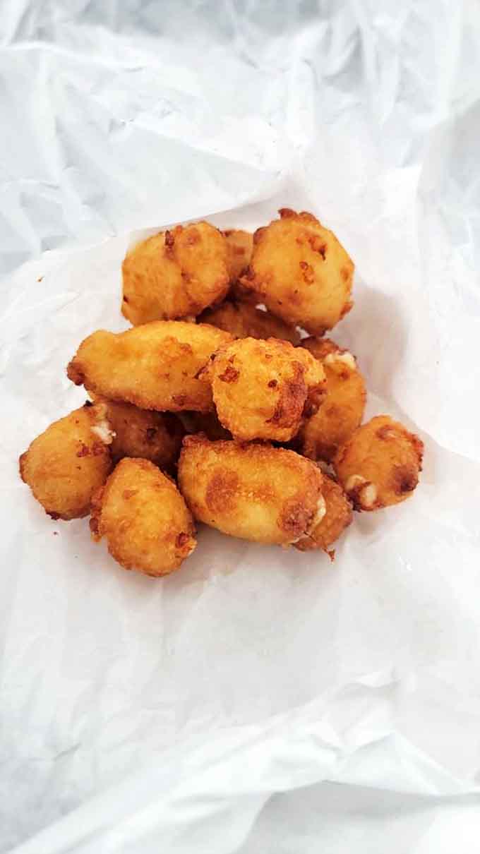 Wisconsin cheese curds are a sacred tradition, and Gilles serves them golden, squeaky, and absolutely irresistible to cheese lovers everywhere.