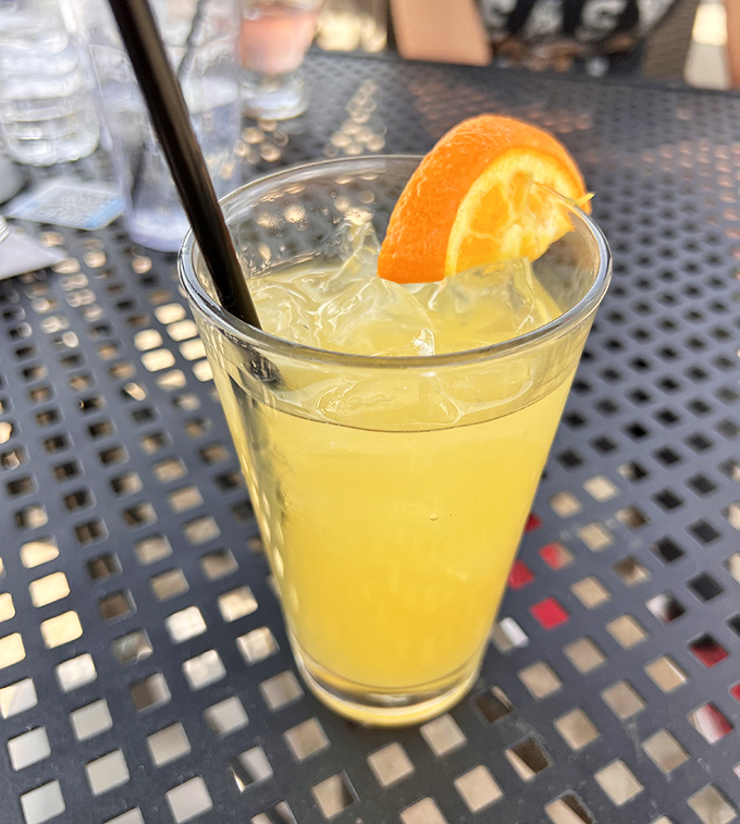 A bright, citrusy cocktail provides the perfect liquid companion to cut through all that cheesy goodness – refreshment in a glass.