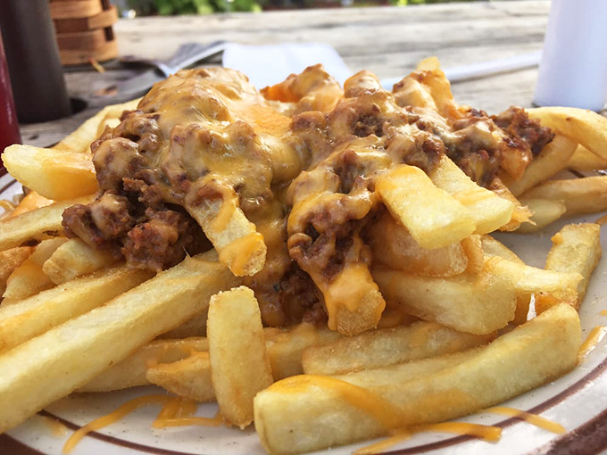 French fries living their best life under a blanket of savory meat sauce and melted cheese, a fork-required indulgence worth every delicious calorie.
