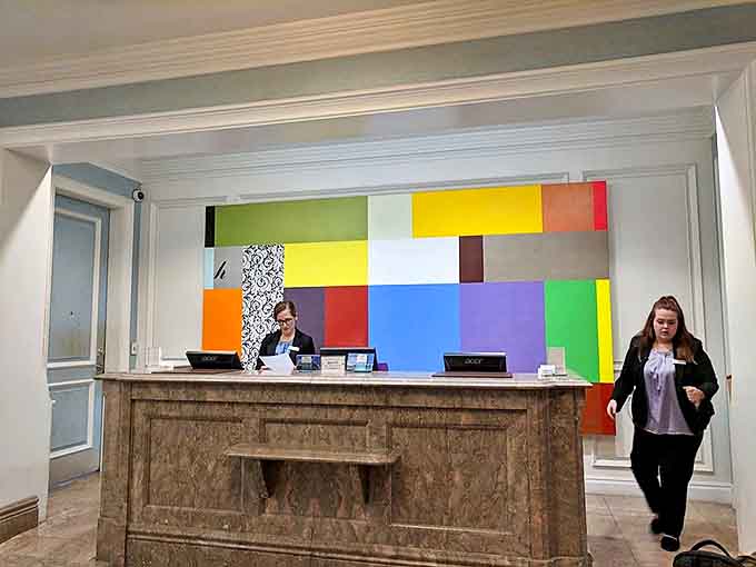 First impressions matter &ndash; the colorful geometric backdrop at reception signals this isn't your standard hotel check-in experience.