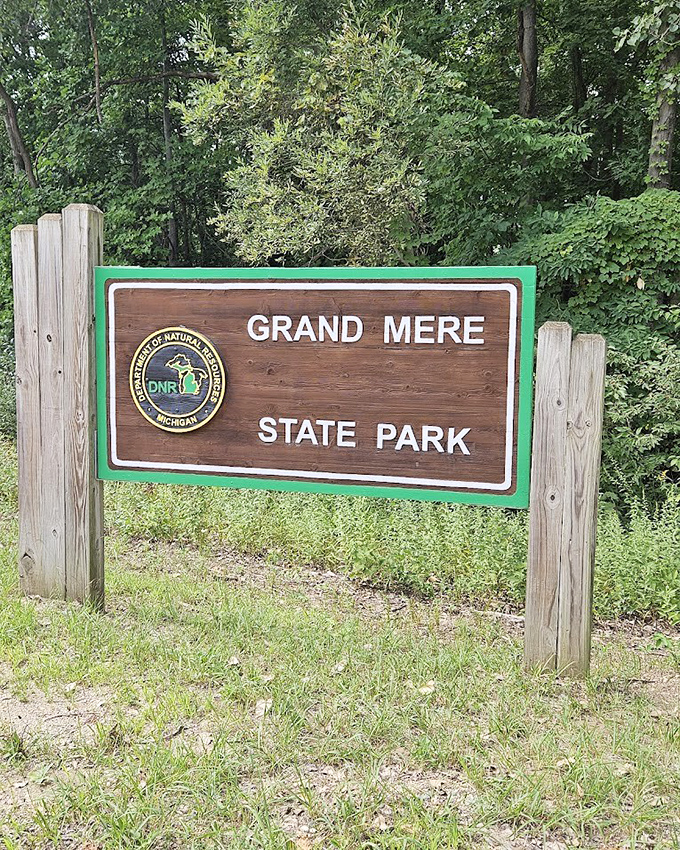 The unassuming entrance sign that marks the boundary between ordinary life and the extraordinary natural wonder waiting beyond.