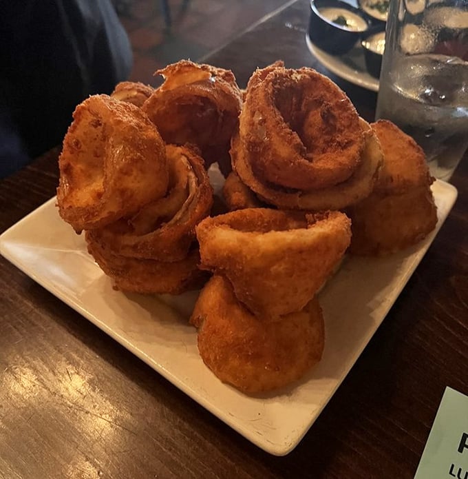 Golden onion rings that crunch like autumn leaves &ndash; these aren't mere sides, they're crispy halos of perfection.