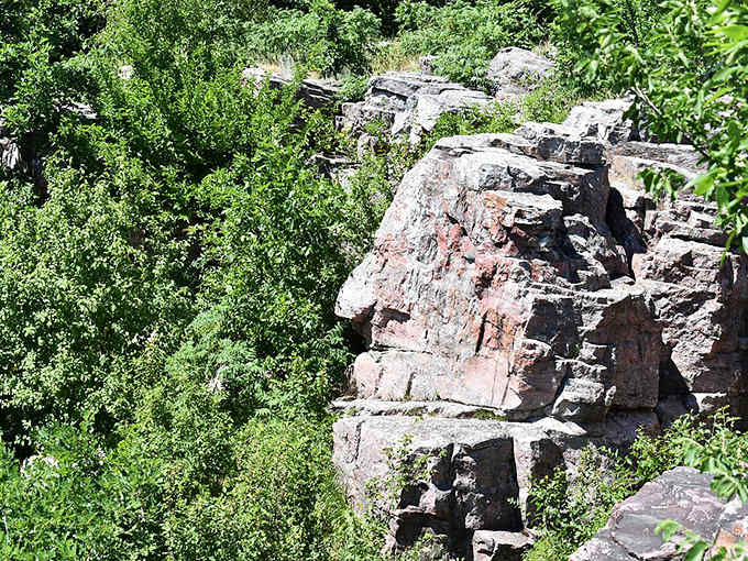 Ancient stone formations seem to watch over the prairie like sentinels from another time, weathered by centuries yet standing strong.