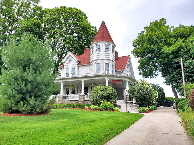 The manicured grounds frame this architectural beauty, where every season brings new colors to complement that distinctive red roof.
