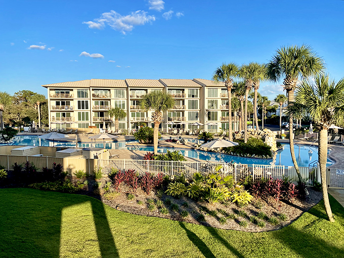 A swimming pool shaped like nature's own artwork, surrounded by palm trees standing guard like elegant sentinels.