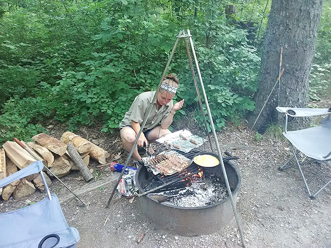 Outdoor cooking reaches its primal best when dinner sizzles over open flames, proving that food always tastes better with a side of adventure.