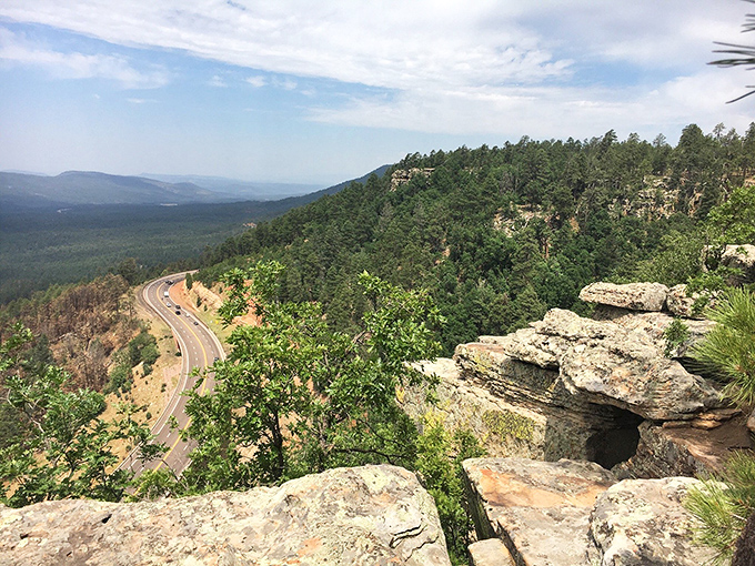 Highway 260 snakes through the landscape below, a reminder of civilization that seems impossibly distant from the rim's wild perspective.