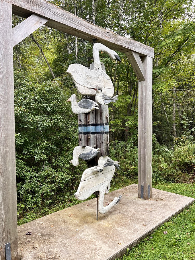 Wooden birds perch on a frame, their simplified forms capturing the essence of flight while remaining firmly anchored to their post.