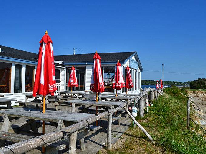 Red umbrellas stand ready for seafood enthusiasts at Spinney's, where lobster is served with a side of spectacular ocean panoramas.