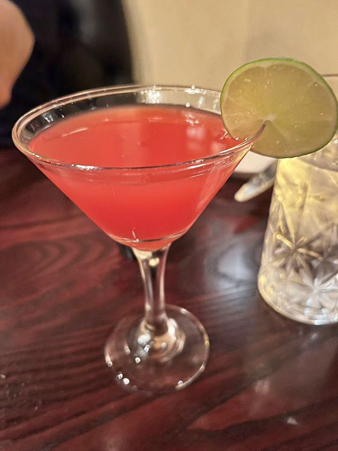This strawberry cosmo isn't just a drink; it's a sunset in a glass, complete with that perfect lime accent.