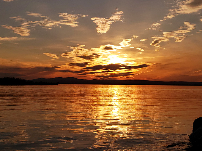 Sunset paints the lake in liquid gold – the magic hour transforms Champlain into a photographer's dream canvas.