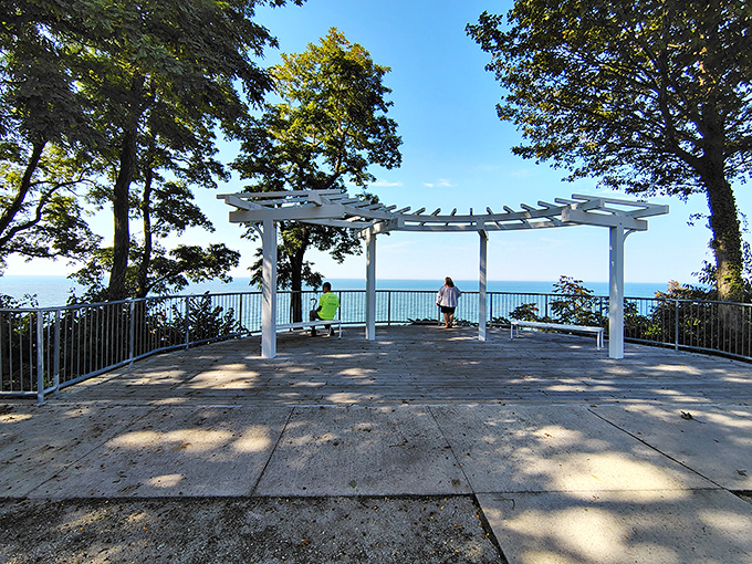 This lakeside pergola frames the perfect Michigan moment, where Lake Michigan's vastness meets architectural elegance in a picture-perfect setting.