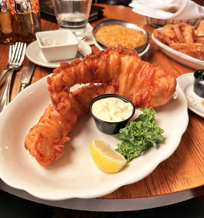 Walleye, Minnesota's beloved state fish, wears its golden beer-battered coat with pride on this perfectly prepared plate.
