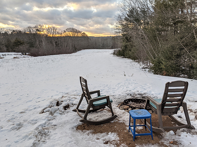 Winter transforms the landscape into a monochrome masterpiece, with fire pits defying the chill of Maine's embrace.