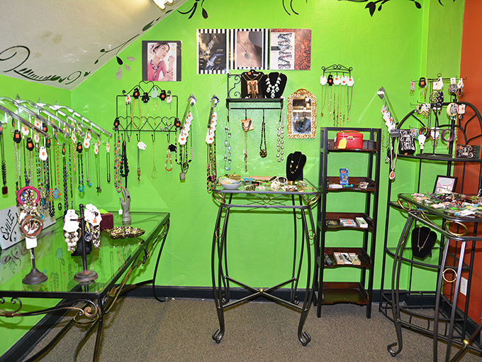 The accessories corner pops with vibrant green walls showcasing jewelry that transforms outfits from "just fine" to "where did you find that?"