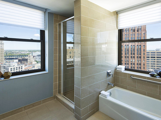 Floor-to-ceiling windows bring Detroit's skyline right into your bathroom &ndash; just remember to close the blinds before showering!