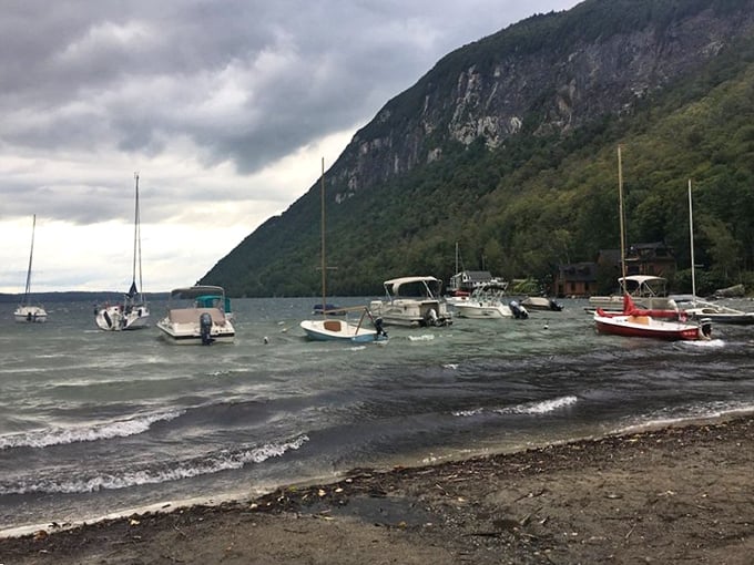 Small boats dot the shoreline, ready to carry anglers to where the legendary lake trout lurk in Willoughby's depths.