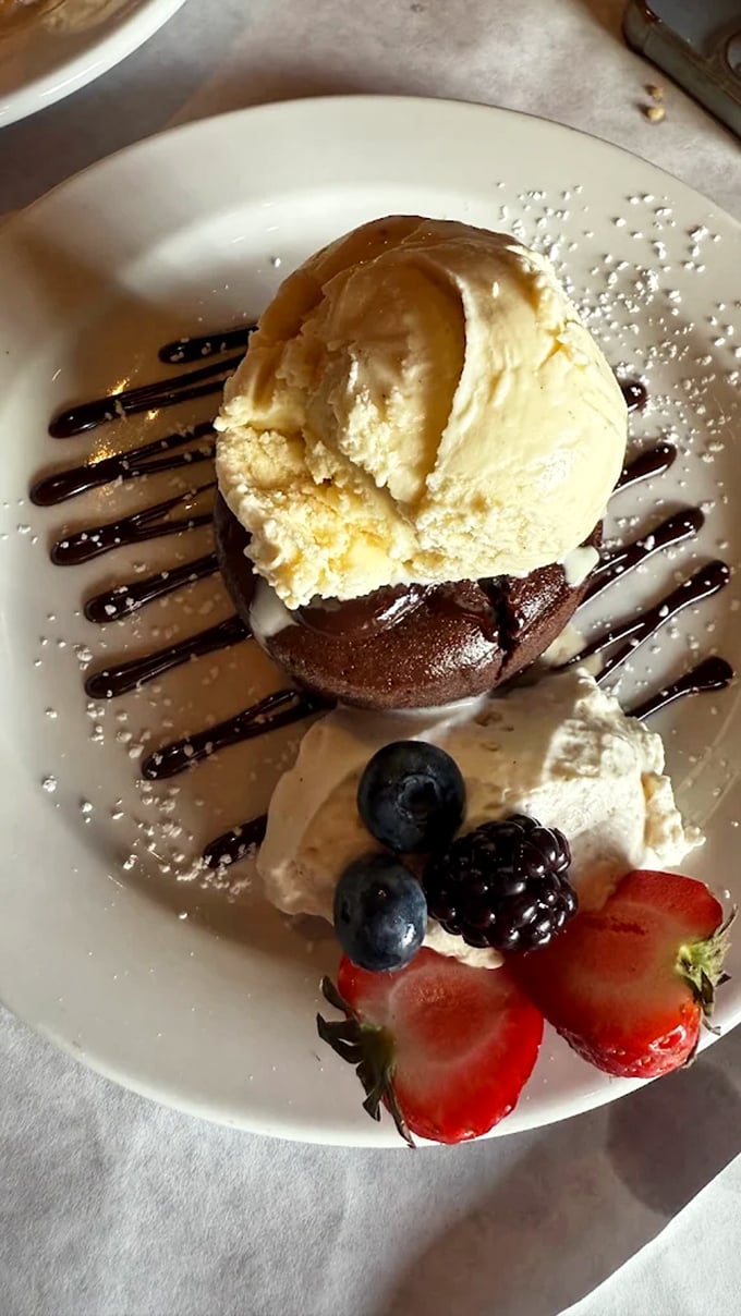 Chocolate lava cake with its molten heart meeting vanilla ice cream creates the kind of dessert moment that makes you believe in happiness.