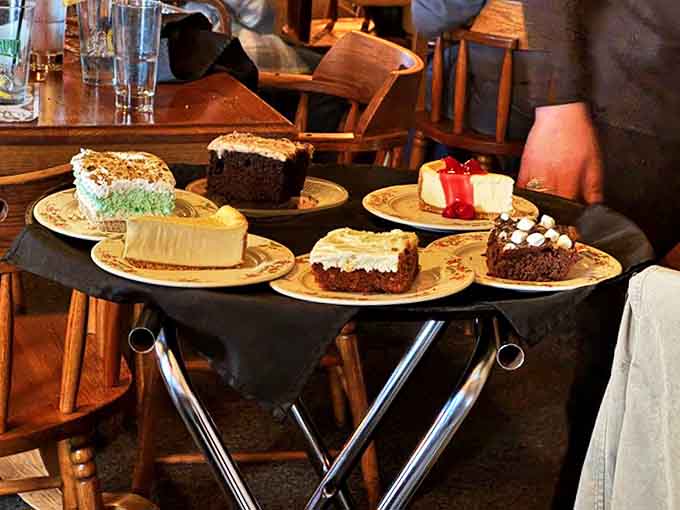 The dessert tray's arrival creates a moment of sweet suspense – will it be cheesecake, chocolate decadence, or something unexpectedly wonderful?