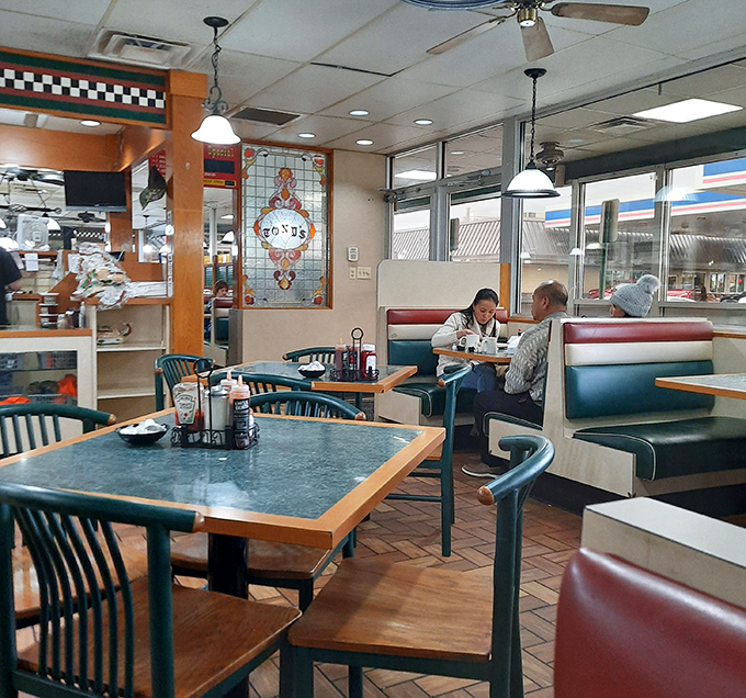 The dining area hums with anticipation as servers deliver architectural food wonders to wide-eyed patrons contemplating their stomach capacity.