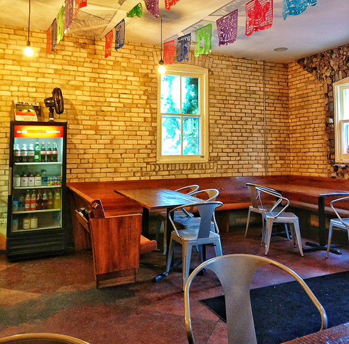 Exposed brick, wooden tables, and colorful accents create the perfect setting for your Mexican food adventure.