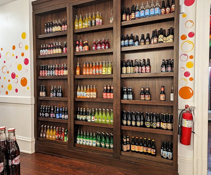 A wall of vintage sodas and craft beverages stands ready to either complement your sugar rush or provide caffeinated reinforcements.