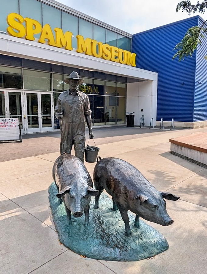 The dignified farmer statue with his pigs stands sentinel outside the museum, a bronze tribute to the agricultural heritage behind America's favorite canned meat.