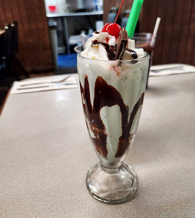 A classic hand-dipped milkshake topped with whipped cream, chocolate drizzle, and a cherry &ndash; thick enough to require serious straw strength.