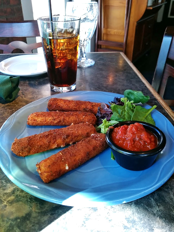 Mozzarella sticks elevated beyond bar food status &ndash; perfectly crisp, with that Instagram-worthy cheese pull that makes everyone at the table reach for their phones.