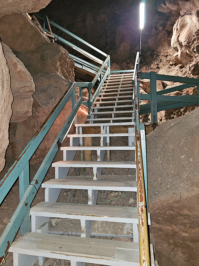 Metal staircases provide access to different levels of the cavern system, each step taking you deeper into Earth's geological timeline.
