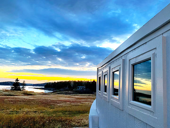 Twilight transforms this beached vessel into a glowing lighthouse, beckoning travelers toward unique slumber rather than safe harbors.