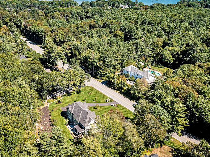 Cumberland Foreside hides its exclusive homes behind protective trees, with just glimpses of rooftops visible from above.