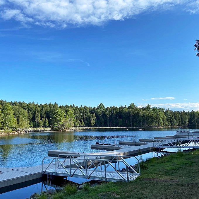 The pristine waters of Moosehead Lake lap gently against Lily Bay's shore, where docks invite summer adventures.