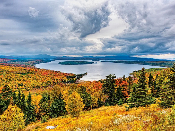 Fall transforms the Rangeley Lakes region into a tapestry of red, orange, and gold, with the vast lake reflecting nature's color show.