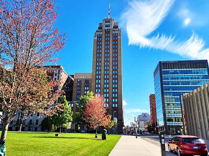 The Michigan State Capitol dome rises above downtown Lansing, its white limestone gleaming against blue skies and surrounded by gardens.