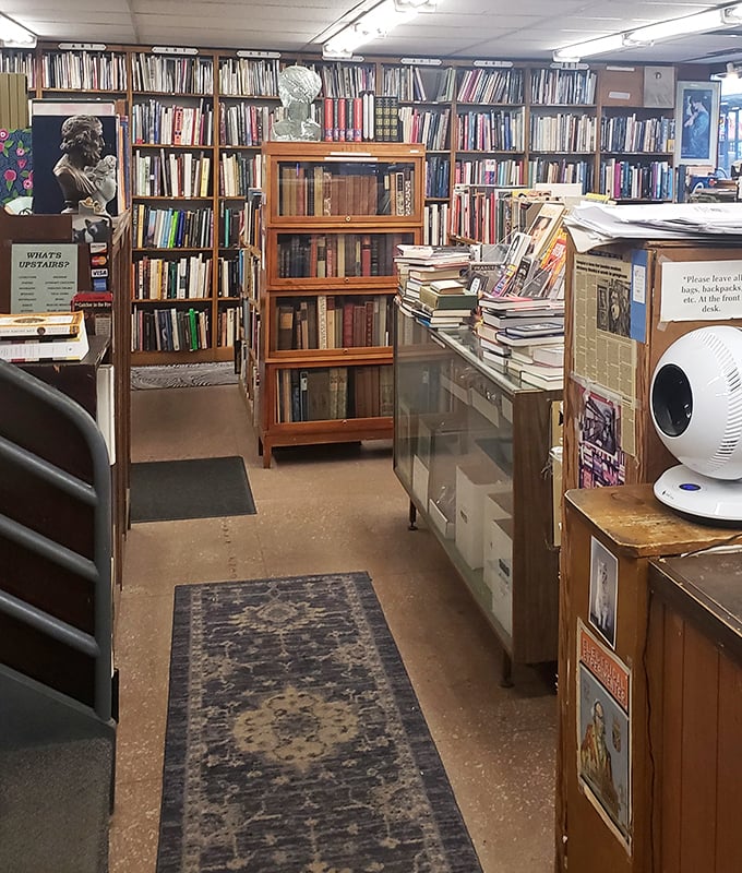 The store's interior reveals itself as a labyrinth of literary possibilities, with glass display cases protecting rare volumes from eager fingers.