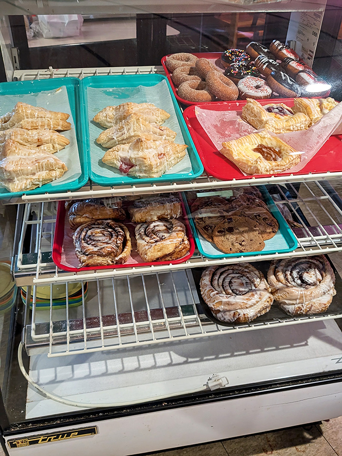 The bakery case &ndash; a glass-fronted museum of carbohydrate artistry where decisions become increasingly difficult with each passing second.