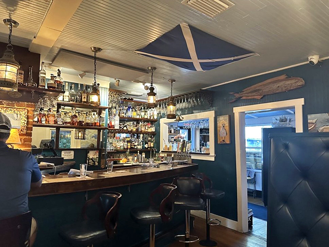 The bar area feels like a captain's quarters, with blue walls, nautical lighting, and a selection of spirits that would impress the most seasoned sailor.
