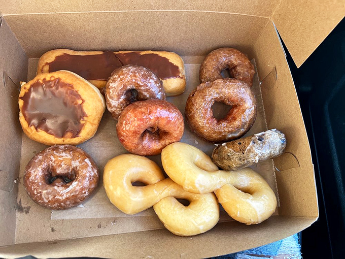 A box of mixed donuts &ndash; the adult version of a treasure chest, filled with glazed, frosted, and sugared gems worth their weight in gold.