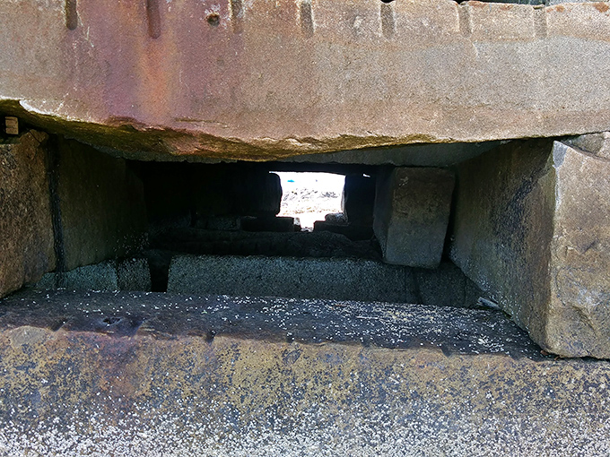Peek through the granite openings reveals the clever design that allows powerful tides to pass without damaging the structure.