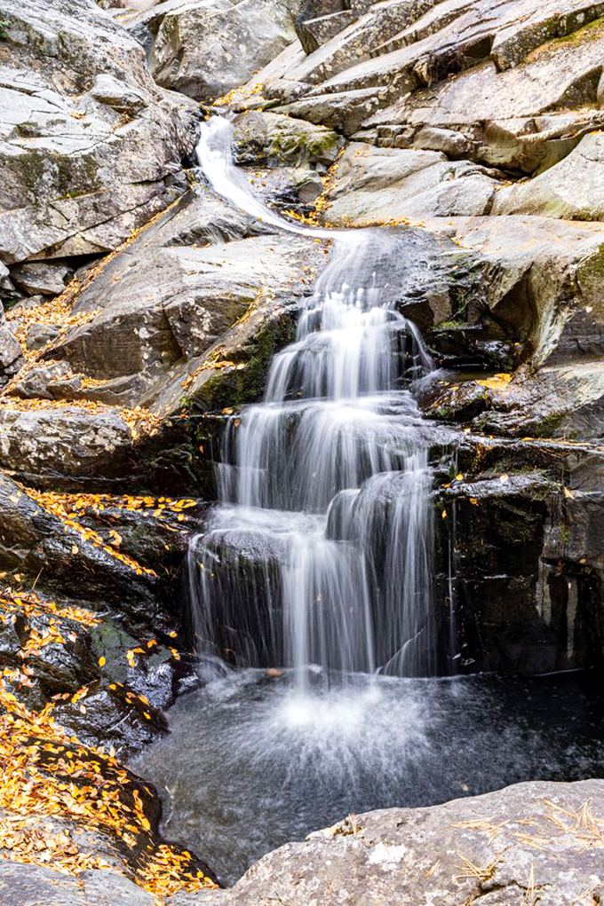 Water transforms from liquid to lace as it cascades down rock faces, creating a spectacle that no smartphone camera truly captures.