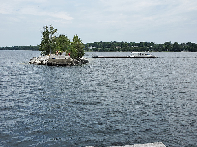 A small island punctuates the vast lake – nature's exclamation point in this watery landscape.