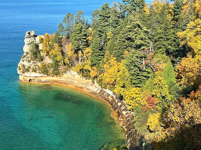 Chapel Rock stands as Lake Superior's natural sculpture garden, where centuries of waves have carved this remarkable formation topped with a determined pine tree.