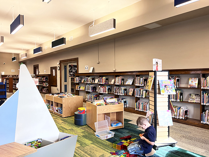 The children's area balances playfulness with functionality, introducing young readers to the magic of books in a welcoming environment.