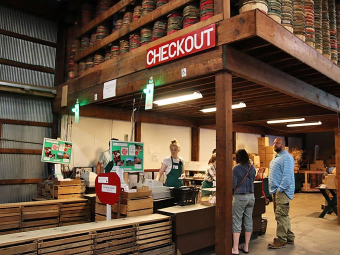 The checkout counter bustles with activity as visitors prepare to take home their orchard treasures, from fresh-picked apples to homemade treats.