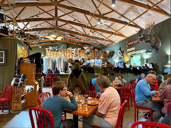 Diners enjoy the warm atmosphere beneath exposed beams &ndash; red chairs pop against green walls while a standing bear watches over the scene.