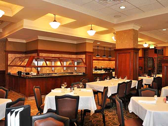White tablecloths and warm wood tones in the dining room create an atmosphere that's both elegant and comfortable, perfect for any occasion.