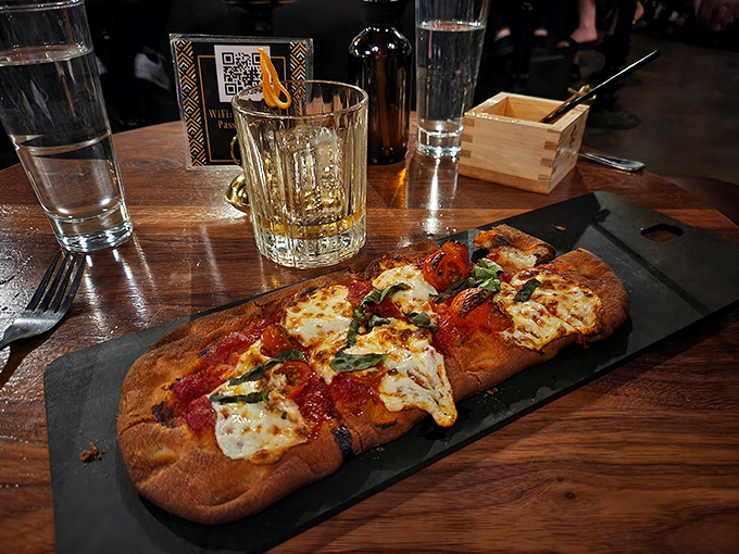 Flatbread that defies expectations: This isn't just pizza – it's a canvas for fresh ingredients that pair perfectly with craft cocktails.